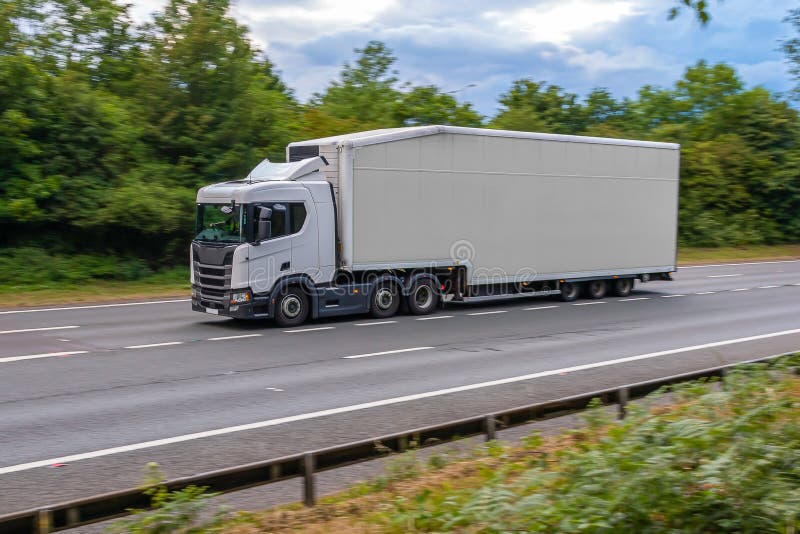 White No Name Double Decker Lorry in Motion on the Motorway. Stock ...