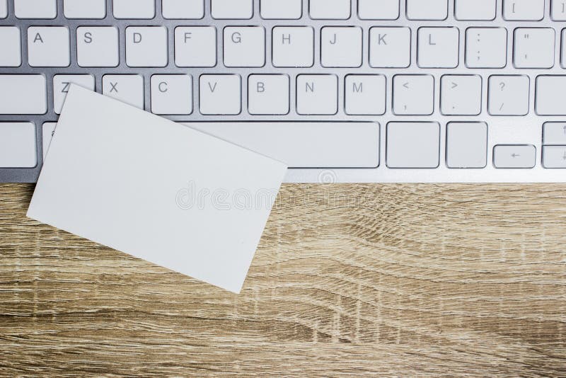A White Note with Keyboard on a Wooden Table. Stock Photo - Image of ...