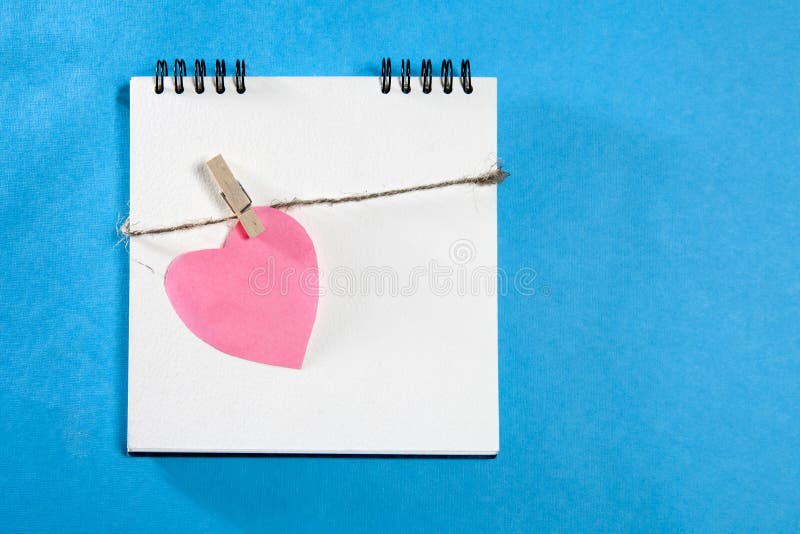 The White Notebook on Springs with a Paper Heart Wrapped in a Rope on a ...