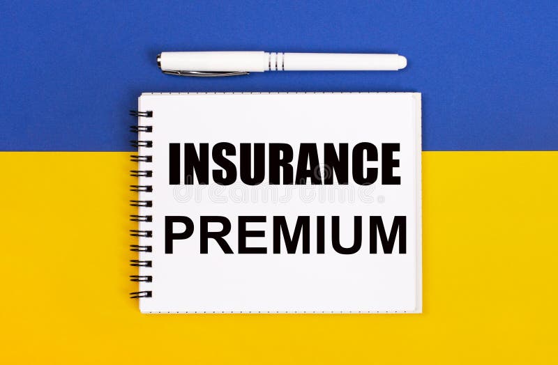 A White Notebook with the Text INSURANCE PREMIUM and a White Pen on a ...
