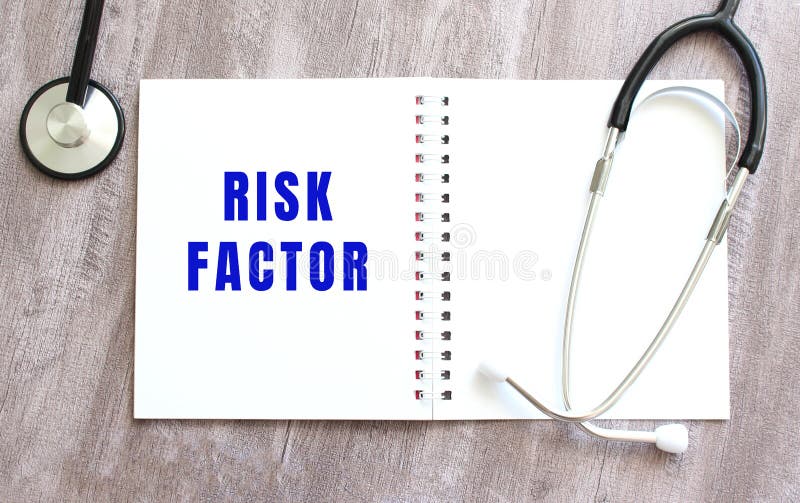 A White Notebook with the Words RISK FACTOR and a Stethoscope on a Gray ...