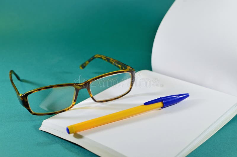 White Notepad.on it are Glasses and a Pen Stock Photo - Image of sight ...