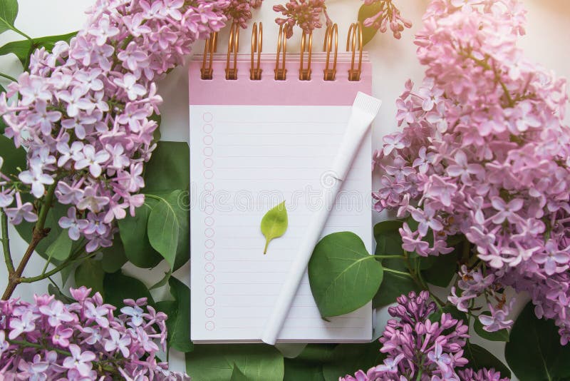 White Notepad for Notes, White Pen among Lilac Spring Flowers Stock ...