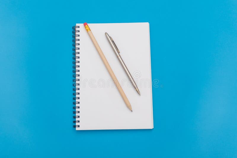 White Notepad with Steel Pen on a Blue Background. Office Table ...