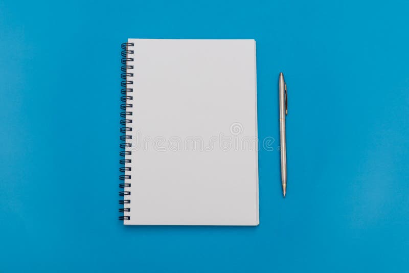 White Notepad with Steel Pen on a Blue Background. Office Table ...