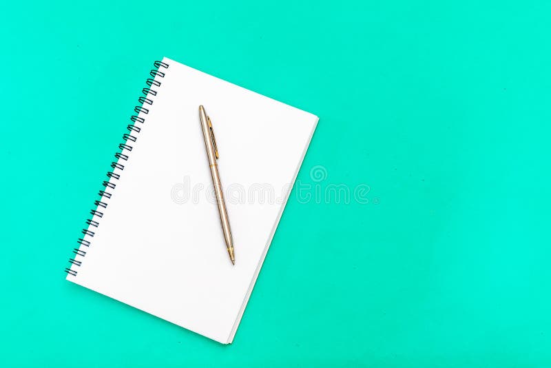 White Notepad with Steel Pen on a Green Background. Office Table ...
