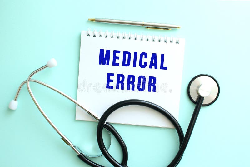 White Notepad with the Words MEDICAL ERROR and a Stethoscope on a Blue ...
