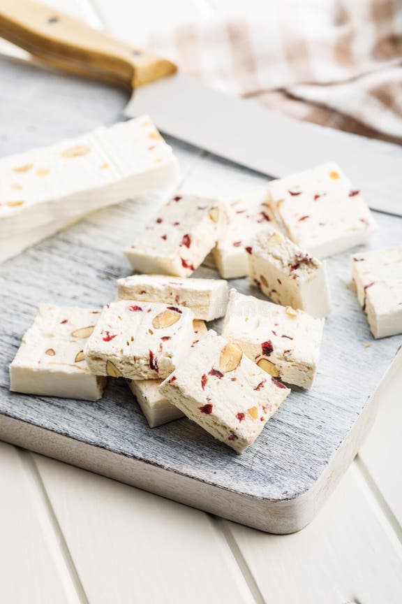 White Nougat Bars with Almonds and Dried Fruit on Cutting Board on ...