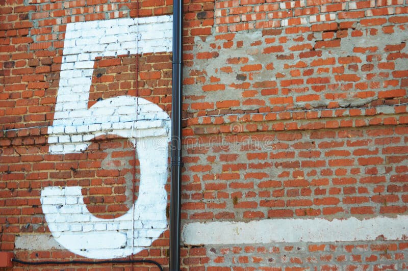 White Number Five Painted on a Red Brick Wall. Number 5 Stock Image ...