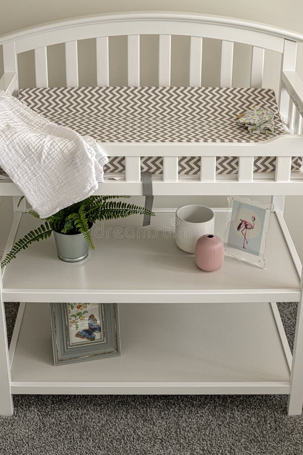 A White Nursery with a White Changing Table and a White Changing Table ...