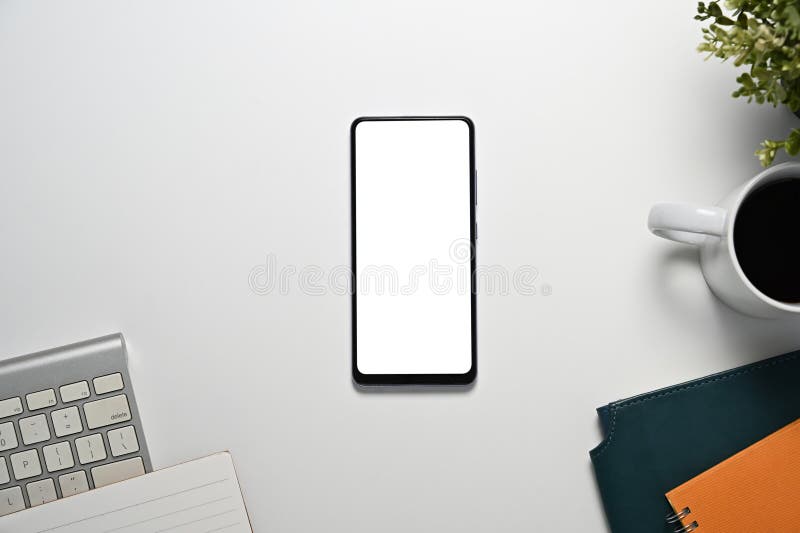 White Office Desk with Blank Smartphone Screen, Keyboard and Notebooks ...