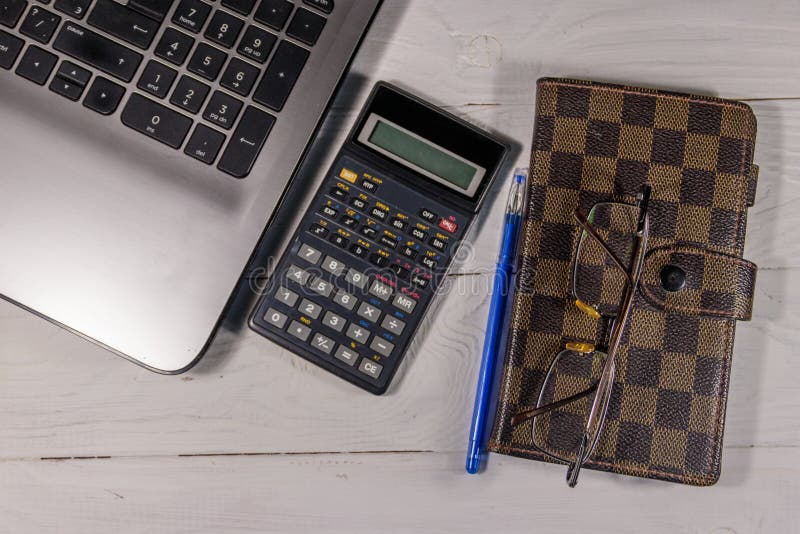 White Office Desk with Laptop, Calculator, Notepad, Eyeglasses and Pen ...