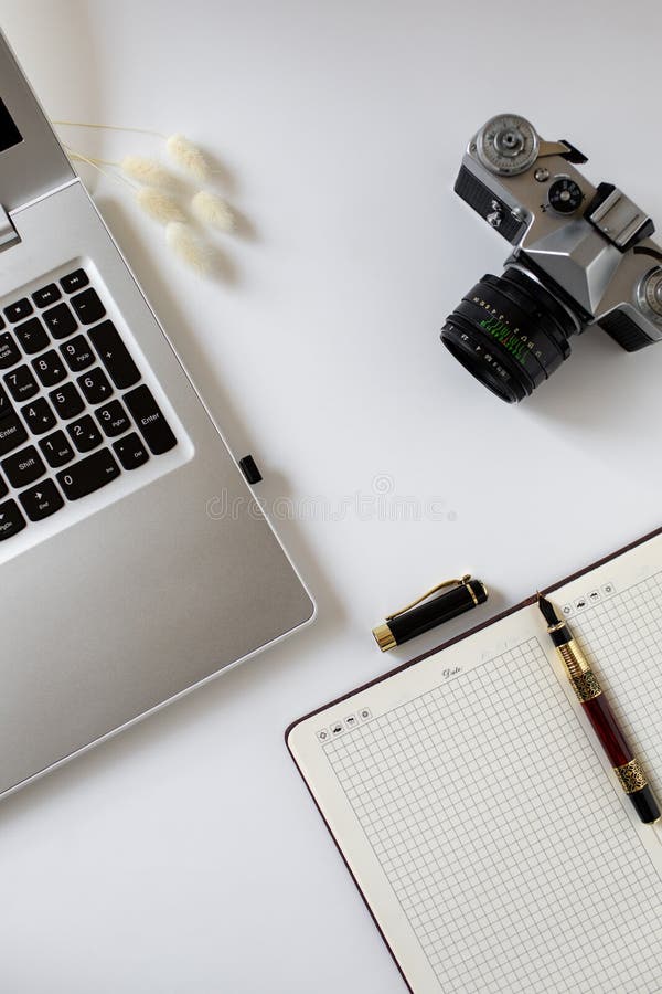 White Office Desk with Laptop, Camera and Notepad. Top View Stock Photo ...