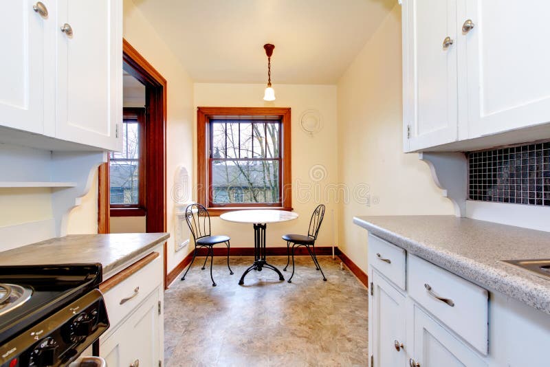 White Old Kitchen with Small Dining Table. Stock Photo - Image of ...