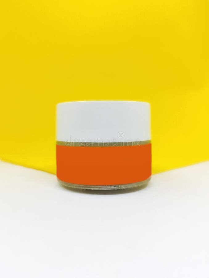White and Orange Glossy Container on Yellow Background Stock Photo ...
