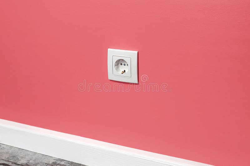 White outlet on pink wall stock photo. Image of plug - 291622242