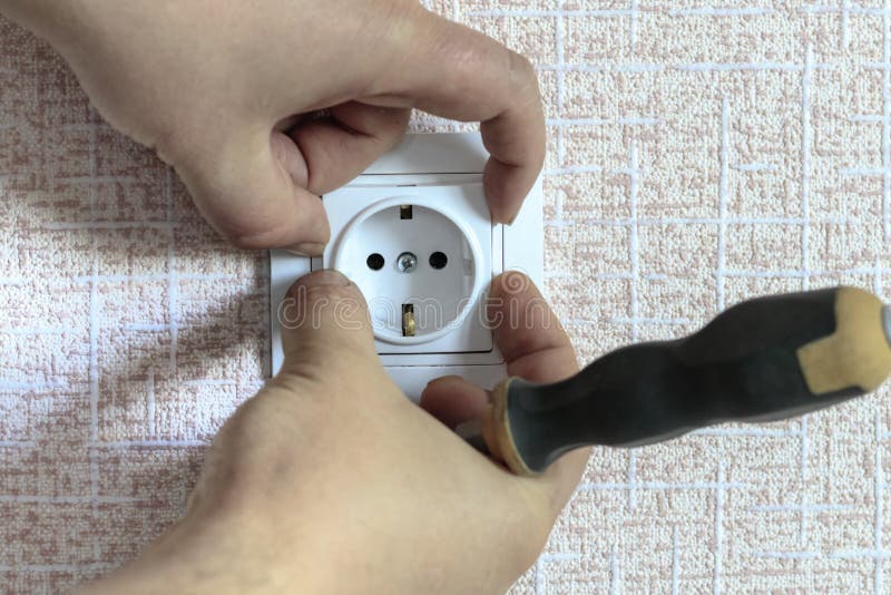 . White Outlet. the Wizard with a Screwdriver Sets it in Place Stock ...