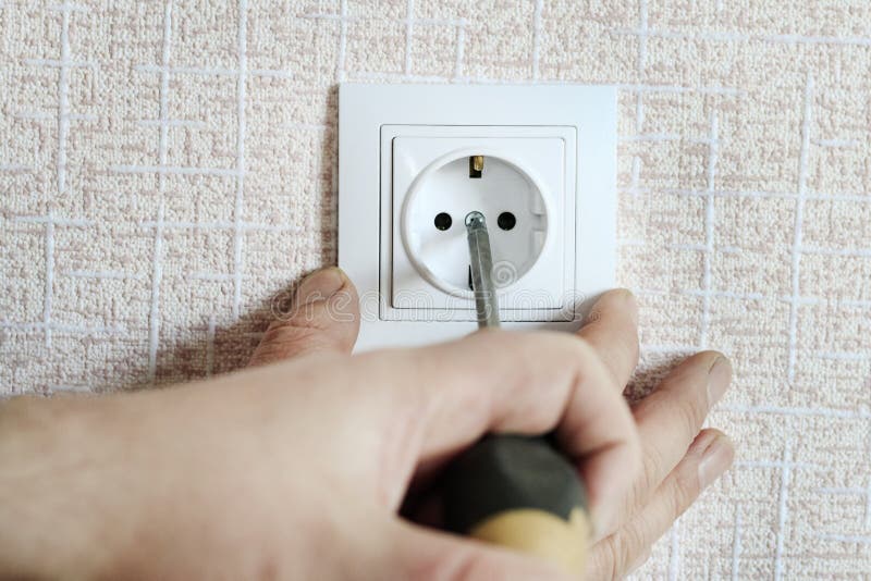 . White Outlet. the Wizard with a Screwdriver Sets it in Place Stock ...