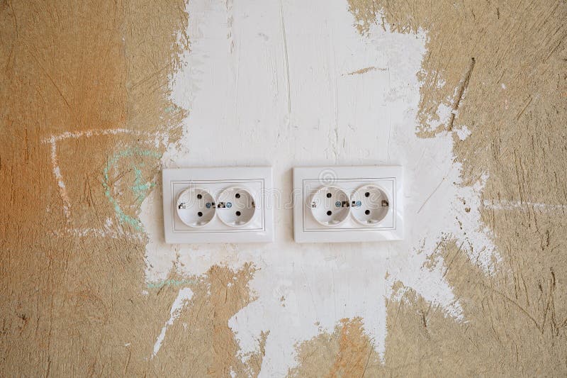 White Outlets on Concrete Wall during Repair. Installation of Sockets ...