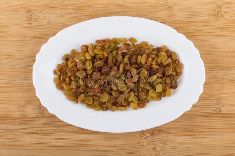 White Oval Dish with Raisins on Wooden Table Stock Image - Image of ...