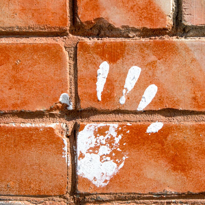 White Paint Print of Right Hand on Red Brick Wall Stock Image - Image ...