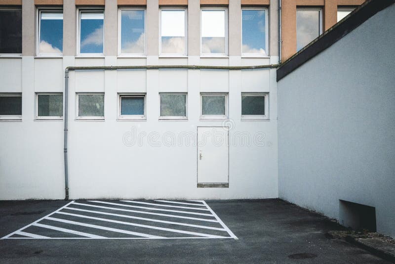 White Painted Building Facade with a Small Yard in Front Stock Photo ...