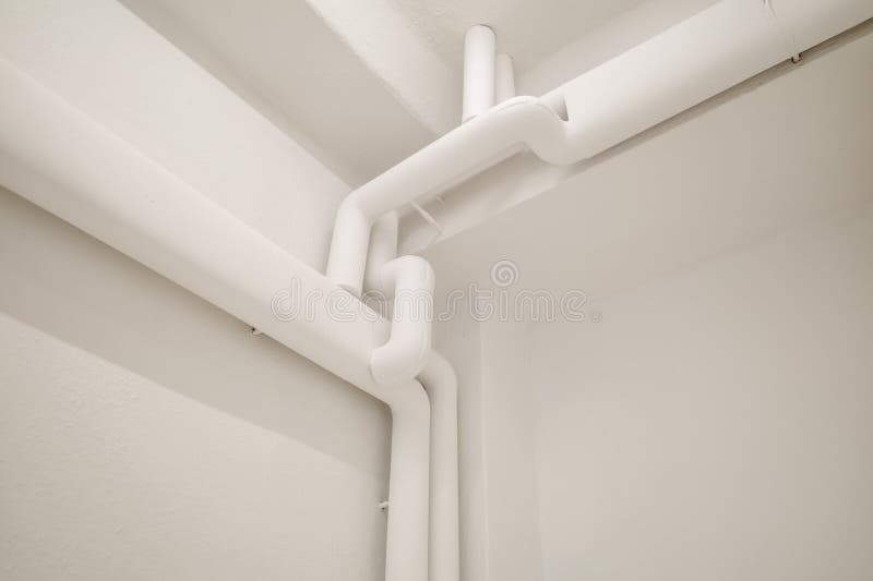 White Painted Pipe System Set Up on the Corner, Ceiling and Wall. Stock ...