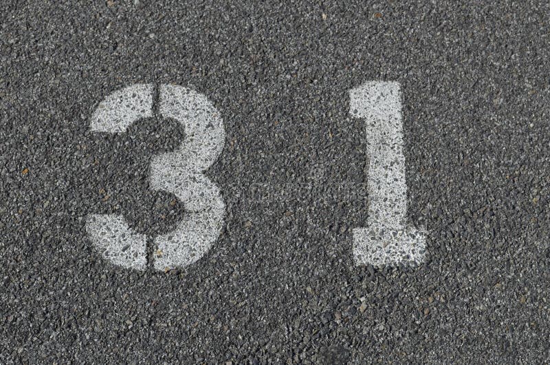 White 31 painted on tar stock image. Image of large - 120751585