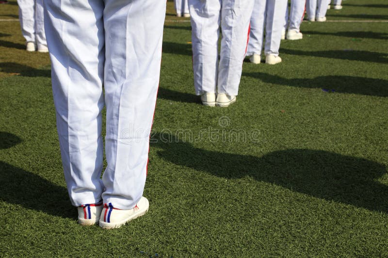 White Pants and Sneakers on the Green Plastic Playground Stock Image ...