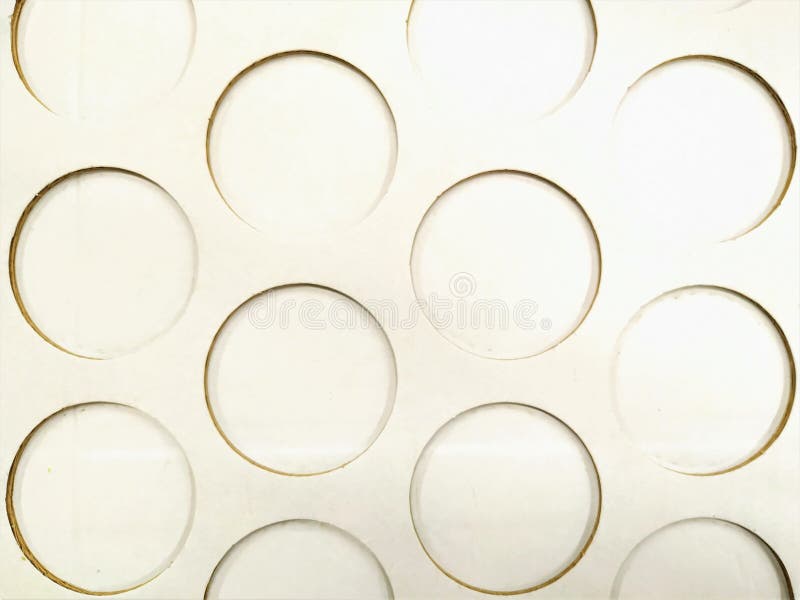 On a White Paper Cardboard There is a Pattern of Cut Out Circles ...