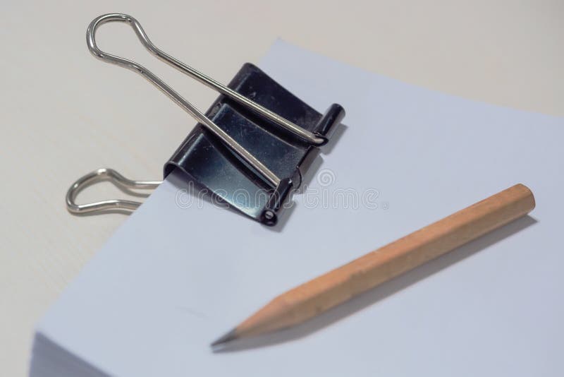 White Paper Clip with Large Black Clips on the Desk Stock Image - Image ...