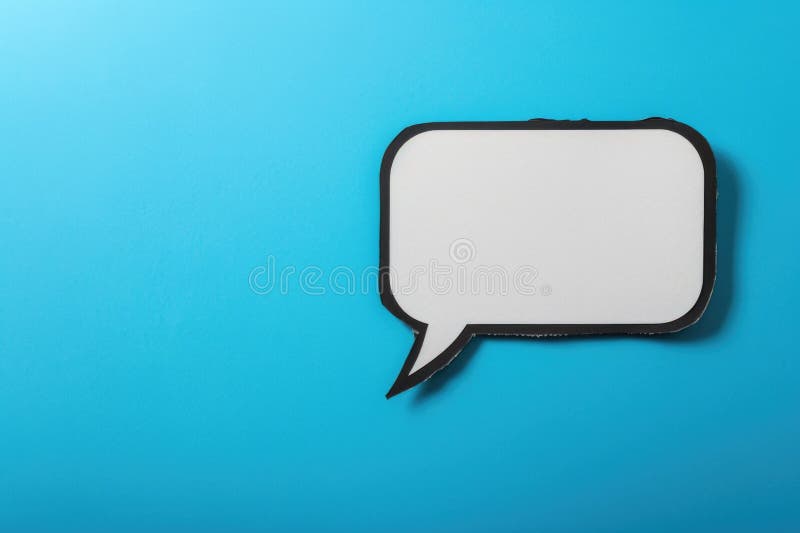 A White Paper Cutout of a Speech Bubble is on a Blue Background Stock ...