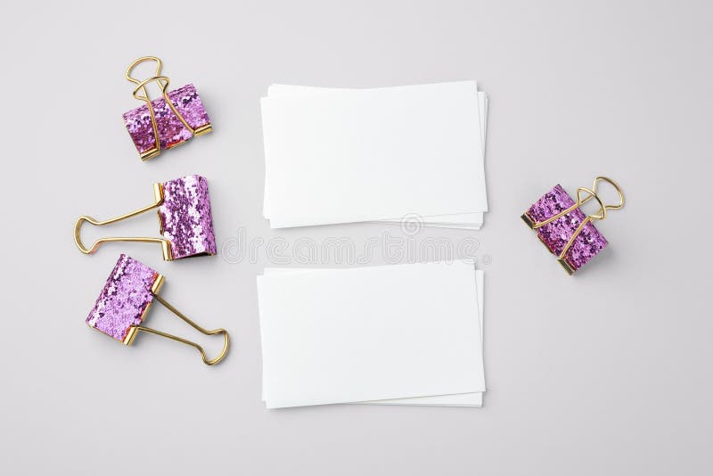 White Paper Note and Pink Glitter Binder Clips on Gray Background Stock ...