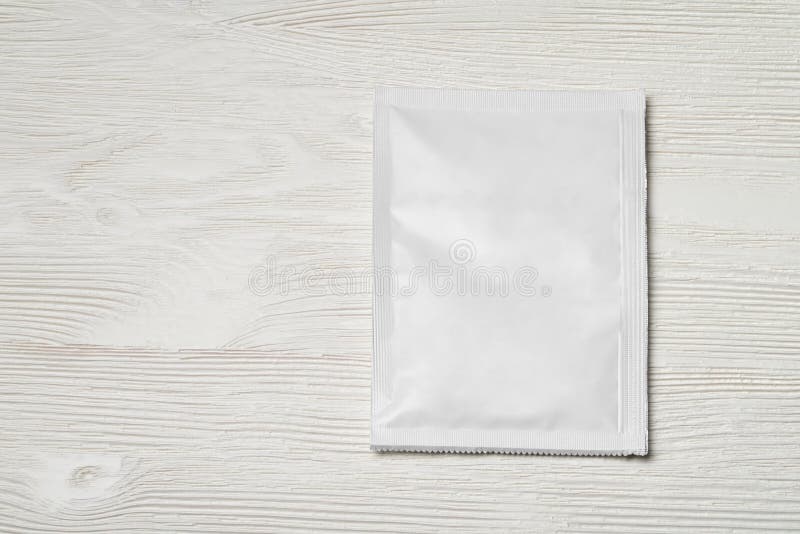White Paper Sachet Packet on Wood Table Stock Photo - Image of pouch ...