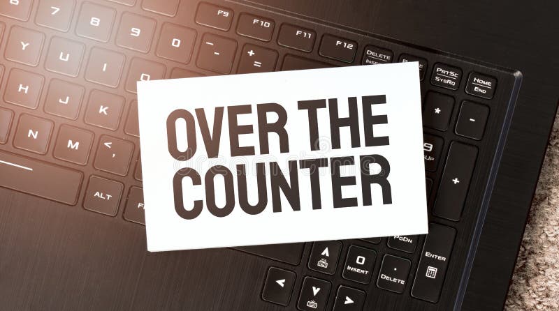 White Paper Sheet with Text OVER the COUNTER on the Black Laptop Stock ...