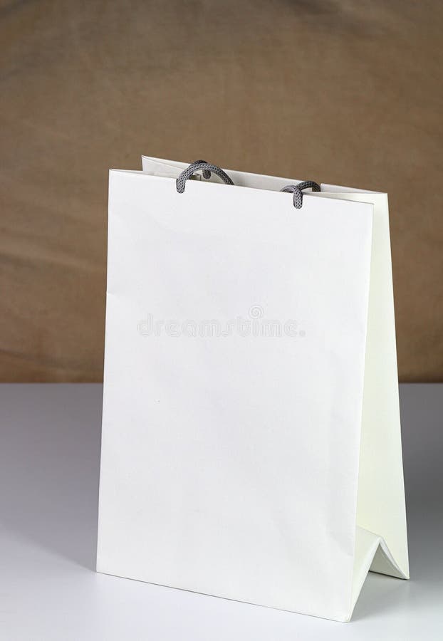 White Paper Shopping Bag, Present Bag Standing on White Table. Stock ...