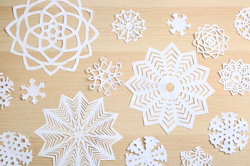 White Paper Snowflakes on Wooden Table, Flat Lay Stock Photo - Image of ...