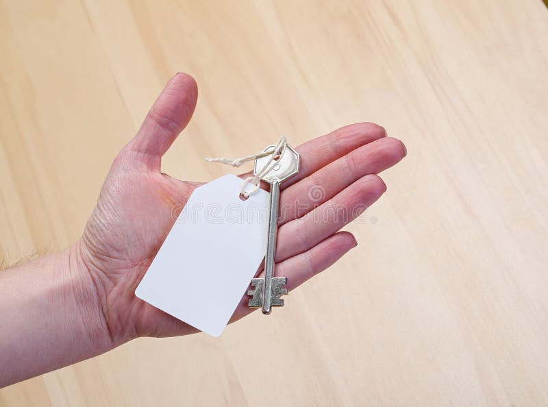 White Paper Tag Attached To the Metal Silver Key in Hand Stock Image ...