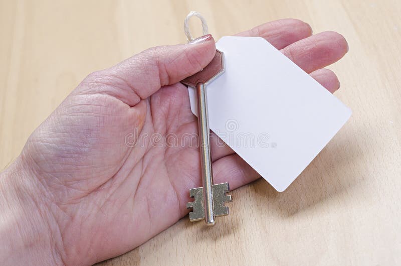 White Paper Tag Attached To the Metal Silver Key in Hand Stock Image ...