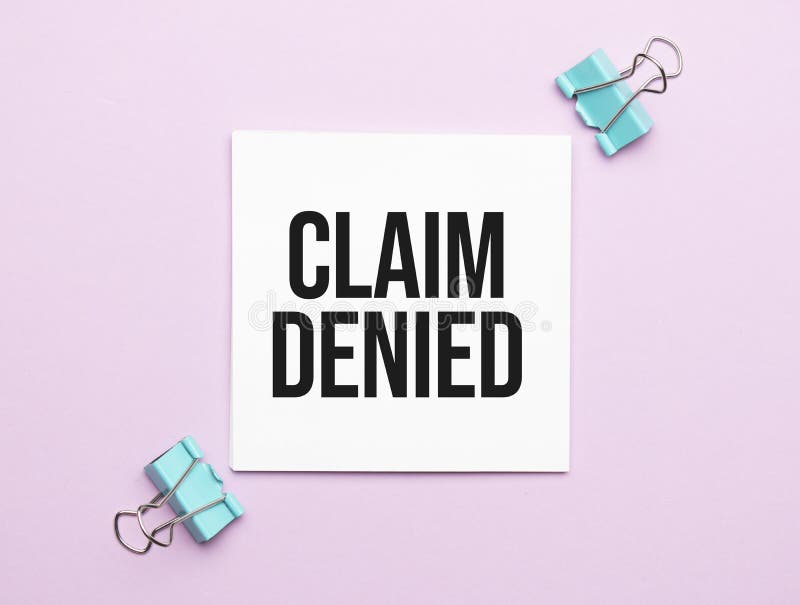 Text CLAIM DENIED on White Paper Sheet and Brown Paper Notepad on the ...