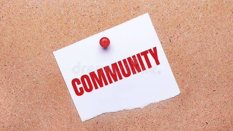 White Paper with the Text COMMUNITY is Attached To the Wooden ...