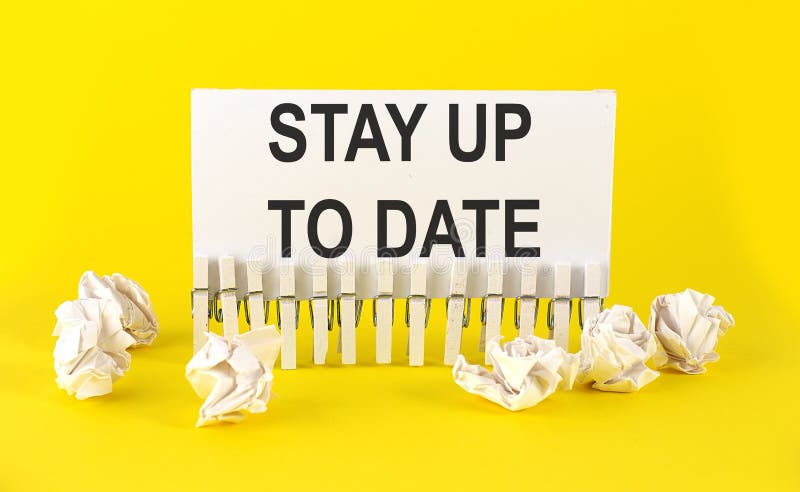 White Paper on the Yellow Background with Text STAY UP TO DATE Stock ...