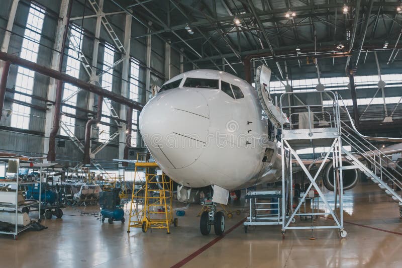 White Passenger Airliner in the Aircraft Hangar. Airplane Under ...