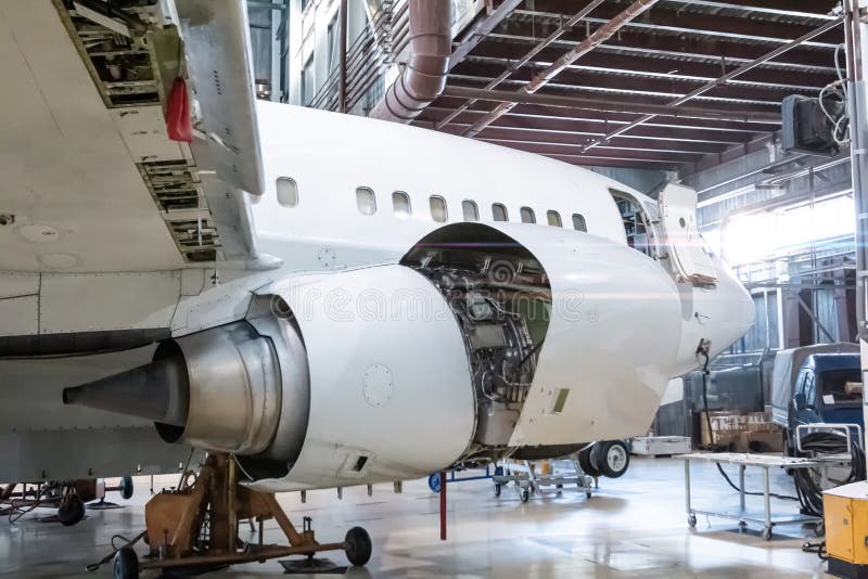 White Passenger Airliner in the Aviation Hangar. Jetliner Under ...