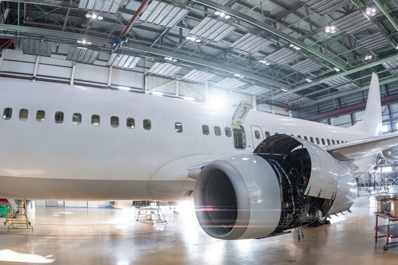 White Passenger Airliner in the Aviation Hangar. Jetliner Under ...