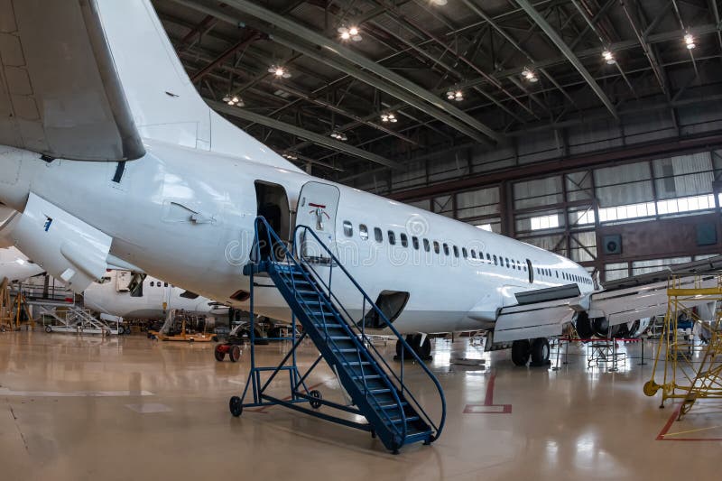White Passenger Airliners in the Aviation Hangar. Jet Planes Under ...