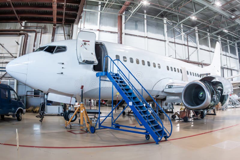 White Passenger Airplane in the Aircraft Hangar. Airliner Under ...