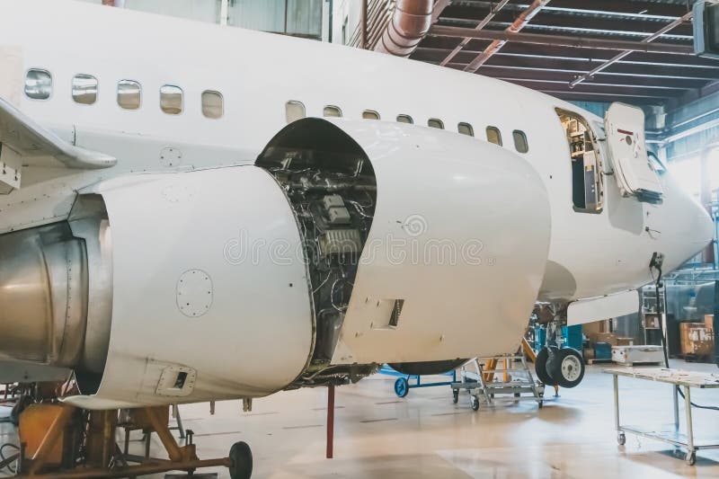 White Passenger Jet Plane in the Airplane Hangar. Airliner Under ...