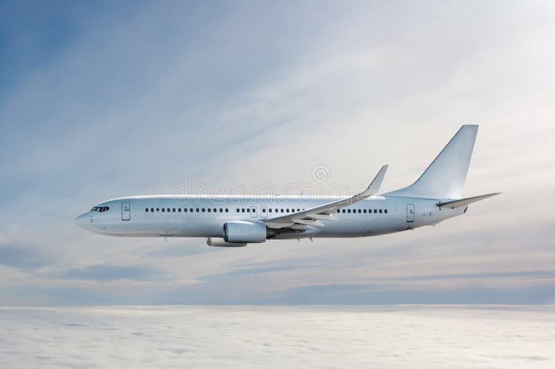 White Passenger Airliner Fly in the Air Above the Clouds Stock Image ...
