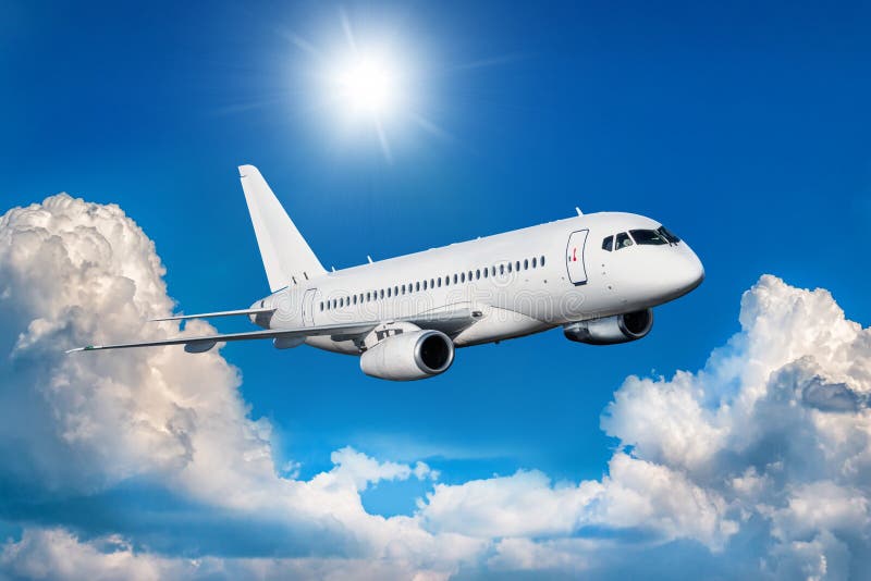 White Passenger Jetliner Fly in the Air Above Picturesque Clouds Stock ...